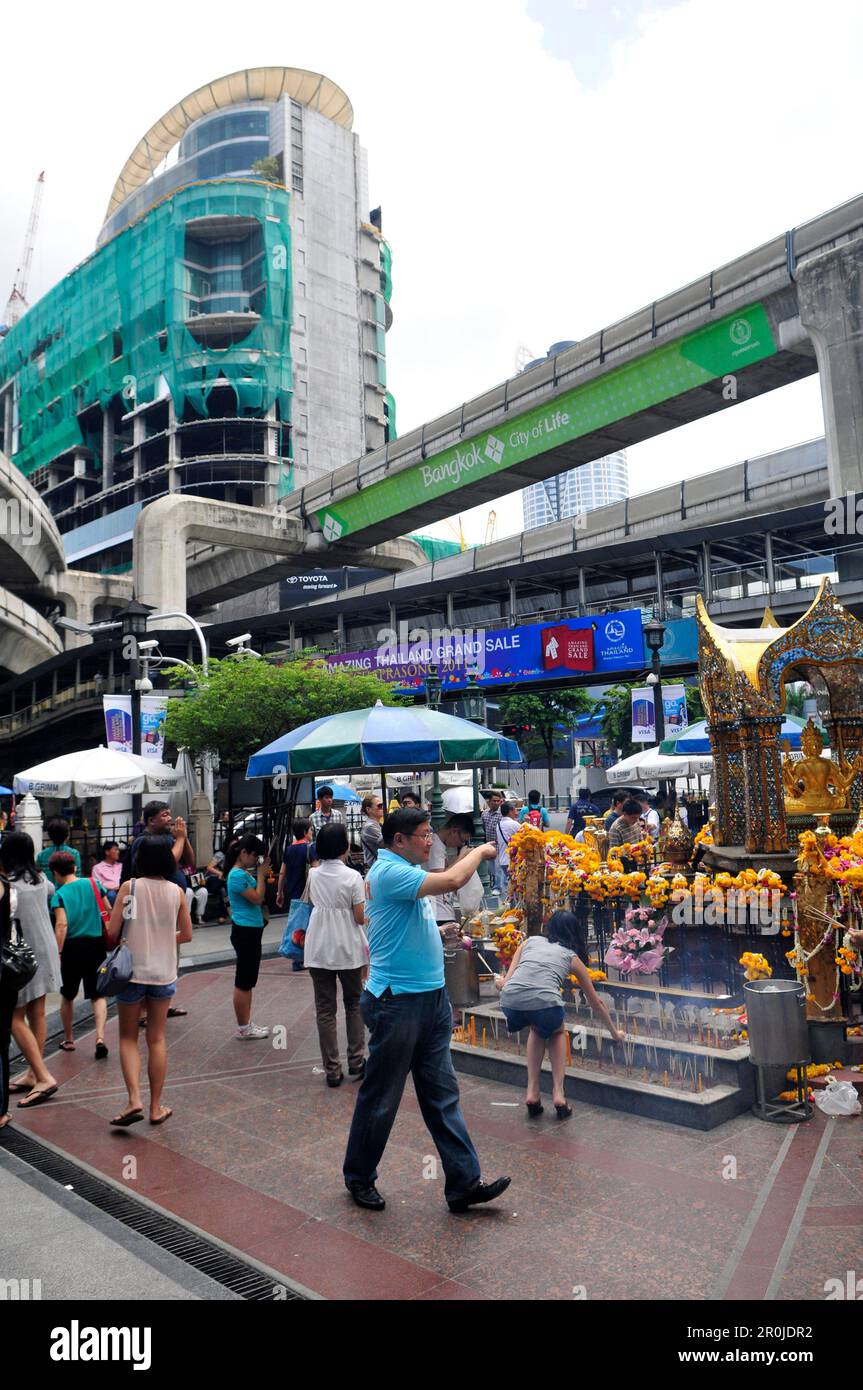 Thai people pray at the Erawan Shrine in Chid Lom, Bangkok, Thailand ...