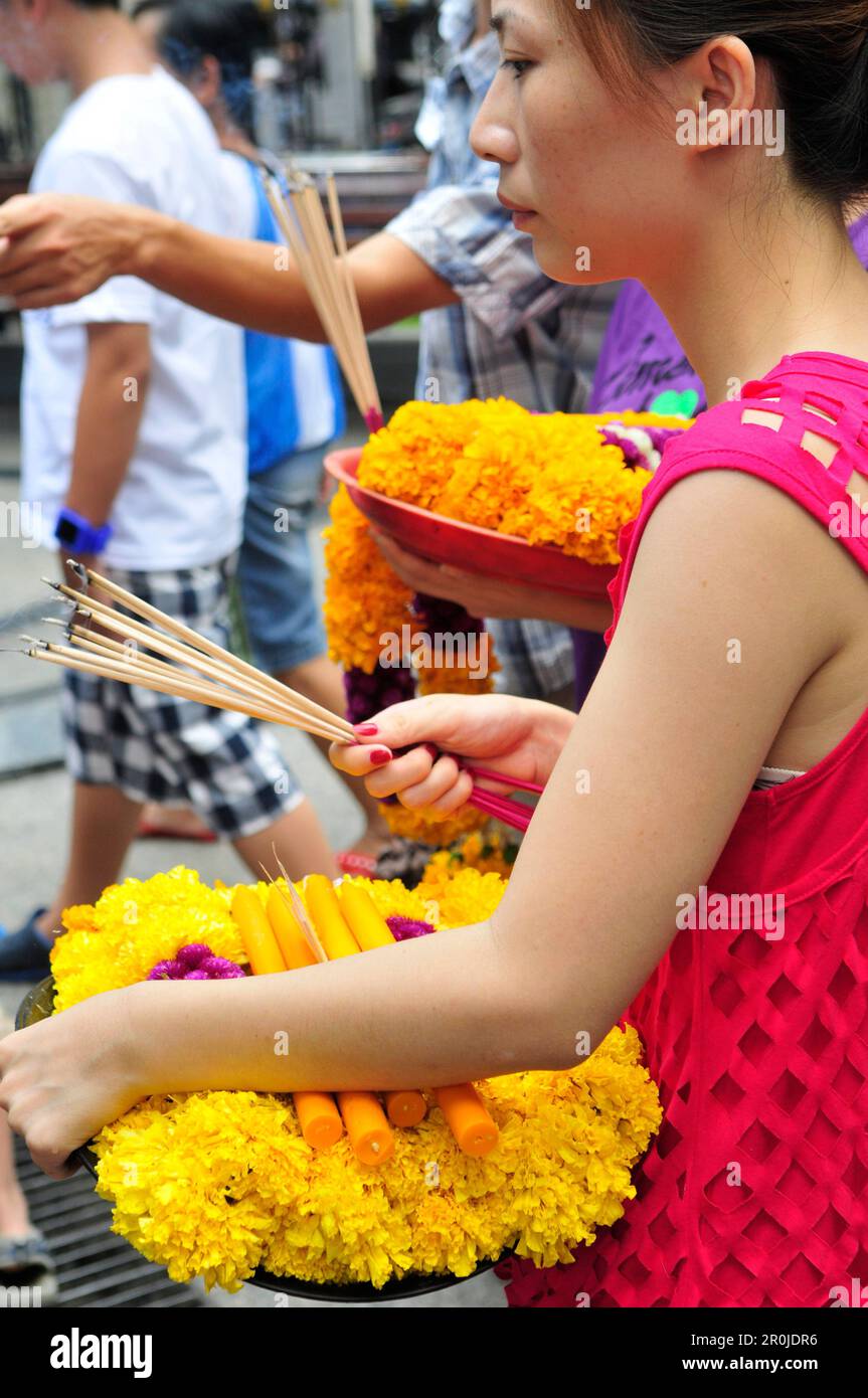Thai people pray at the Erawan Shrine in Chid Lom, Bangkok, Thailand ...