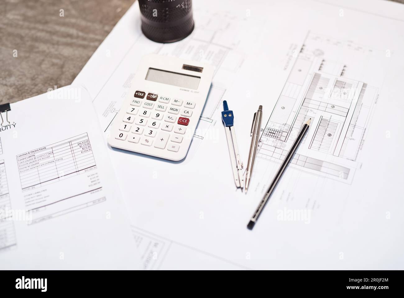 Chapter one of getting the design done. a calculator, pencil, blueprint ...