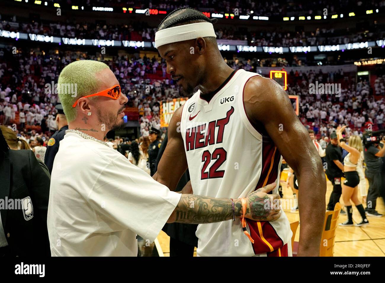 Miami Heat forward Jimmy Butler (22) talks with reggaeton singer J Balvin, of Colombia, after ...