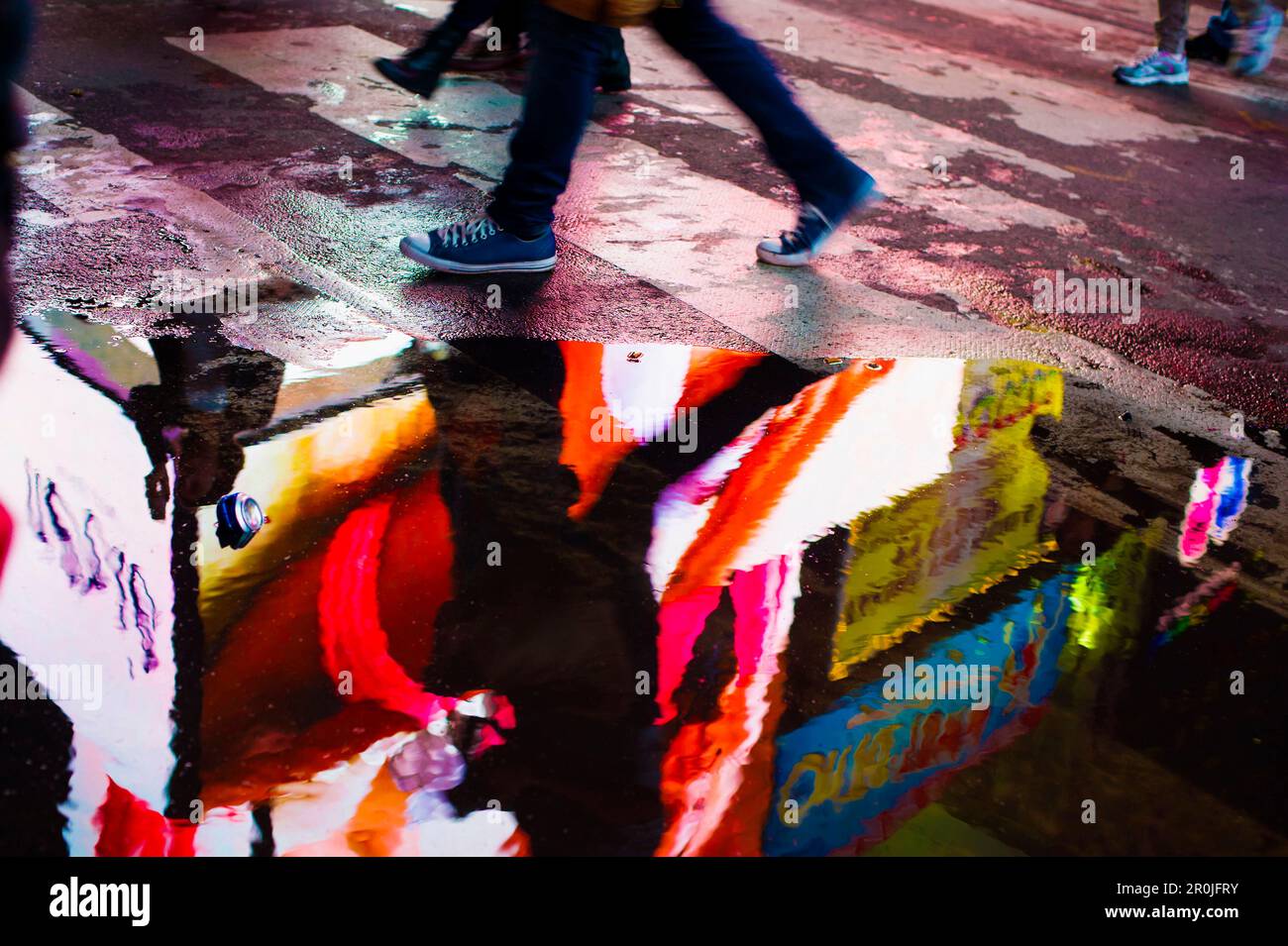 Reflection of a neon sign in a puddle, Times Square, Midtown, Manhattan ...