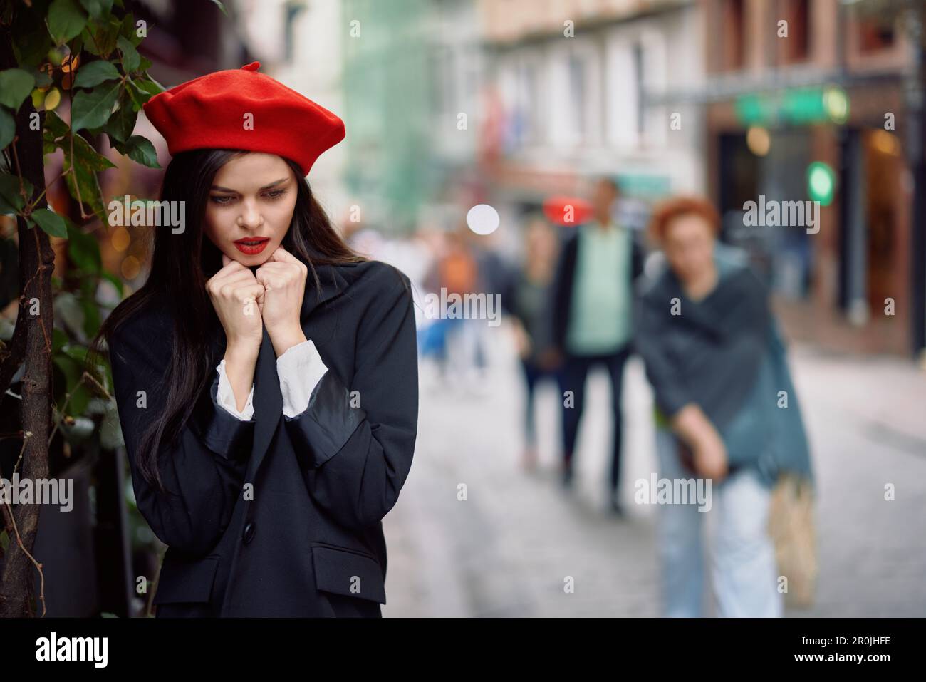 Woman walking down an old city street in a crowd, sociophobia, fear of ...