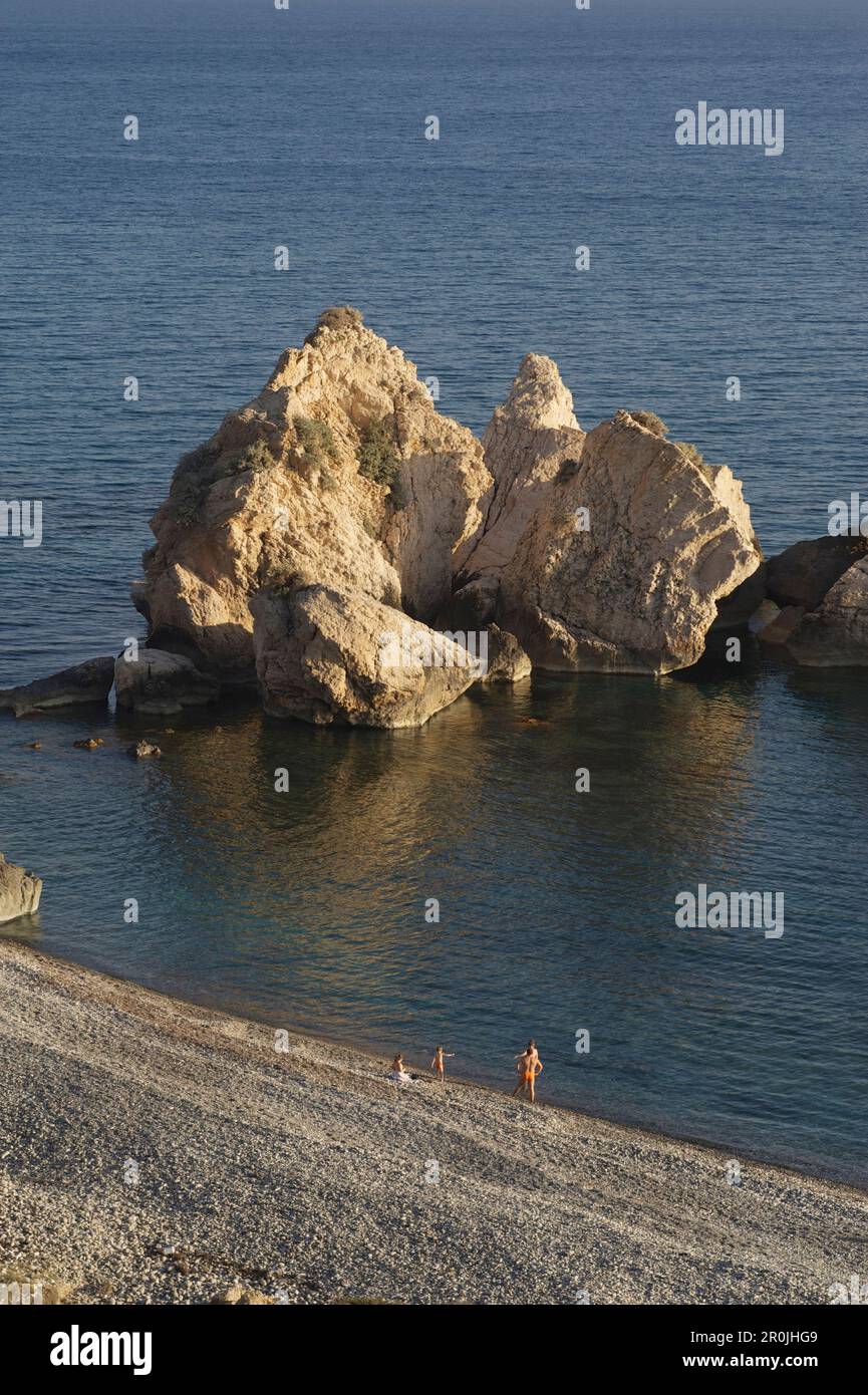 Pebble beach and people bathing in the sea at Petra tou Romiou ...