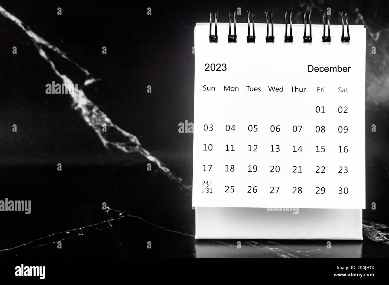 December 2023 Monthly desk calendar for 2023 year on black marble ...