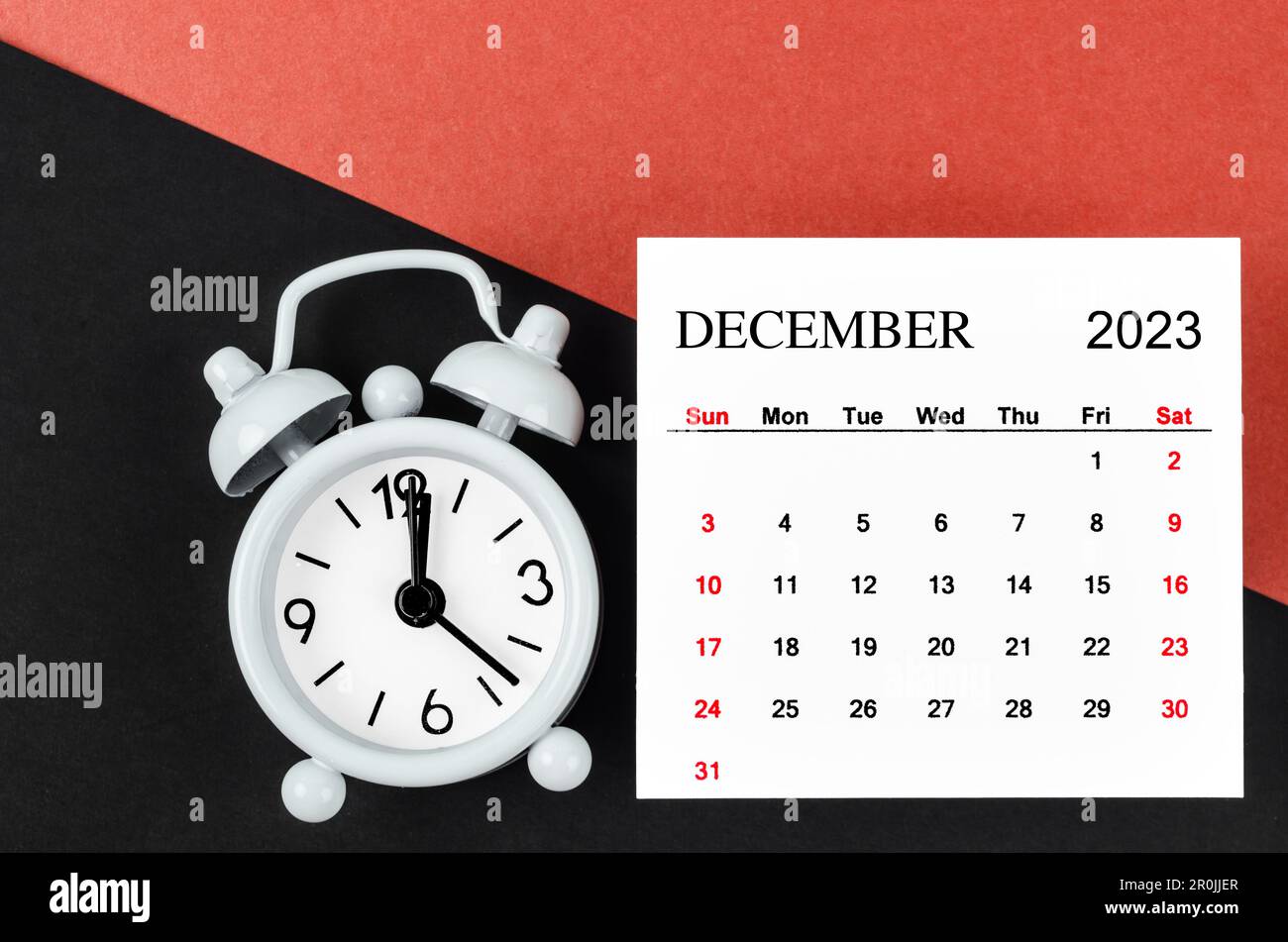 December 2023 Monthly calendar year with alarm clock on red and black ...