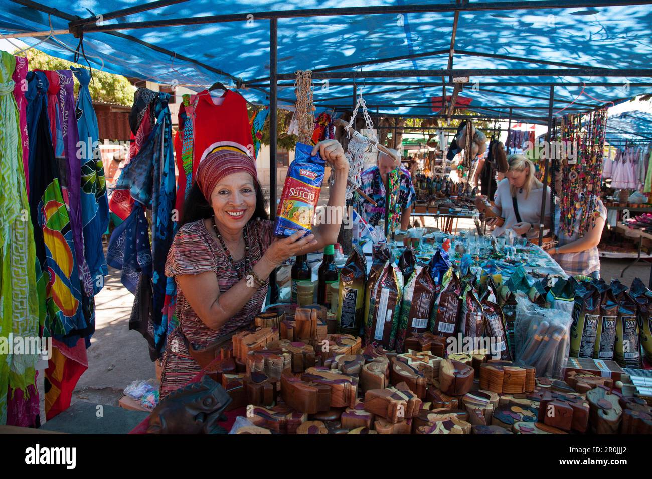 Woman sells coffee beans at souvenir and handicrafts stall at market ...