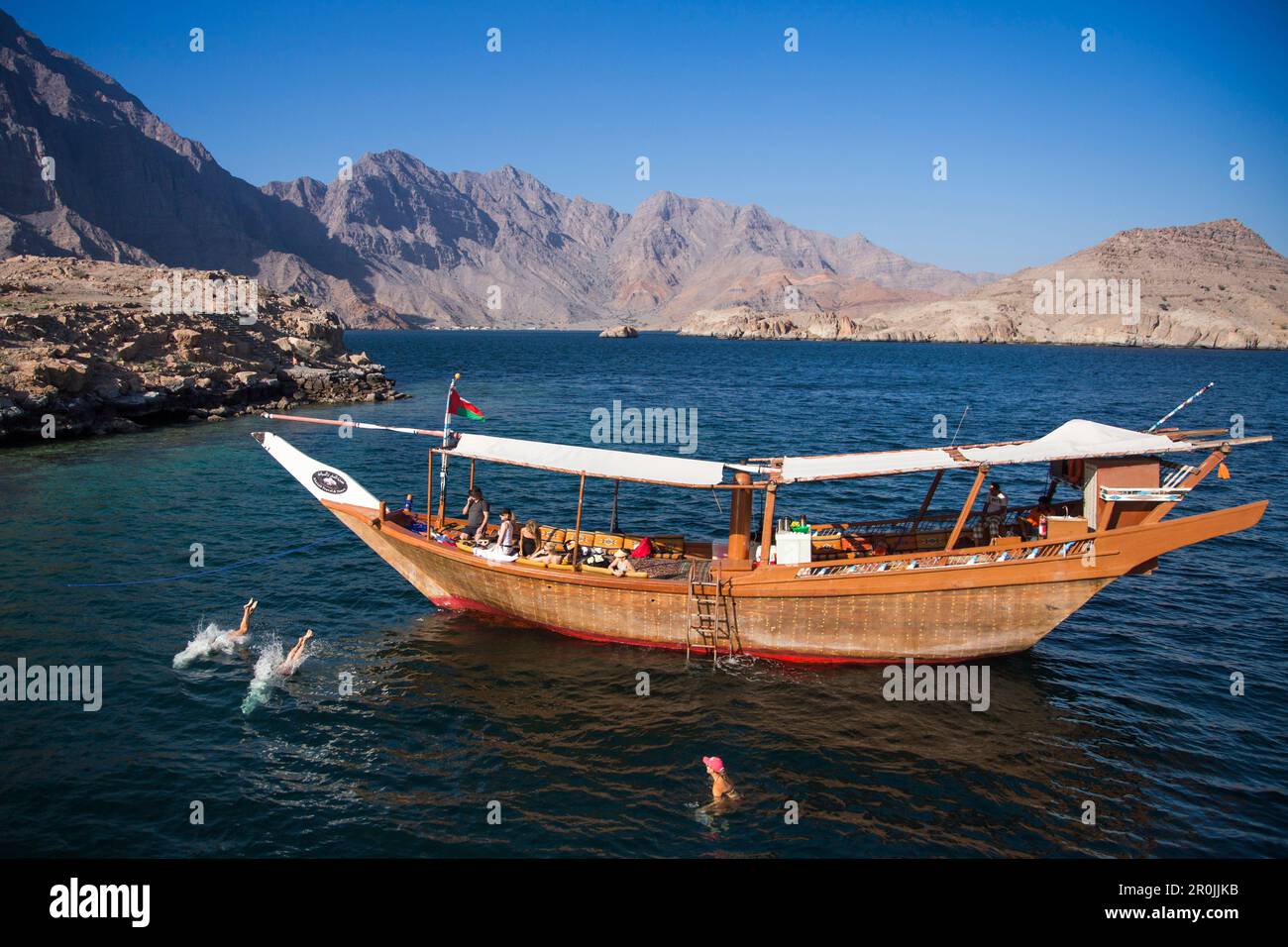 People jump from boat into water during traditional dhow boat excursion ...