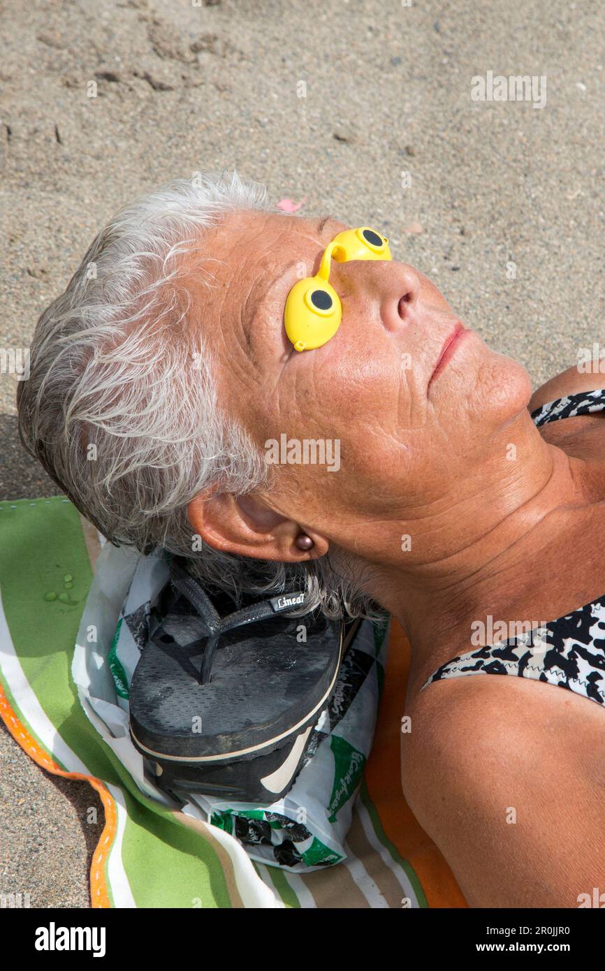Woman sunbathing on beach playa hi-res stock photography and images - Alamy
