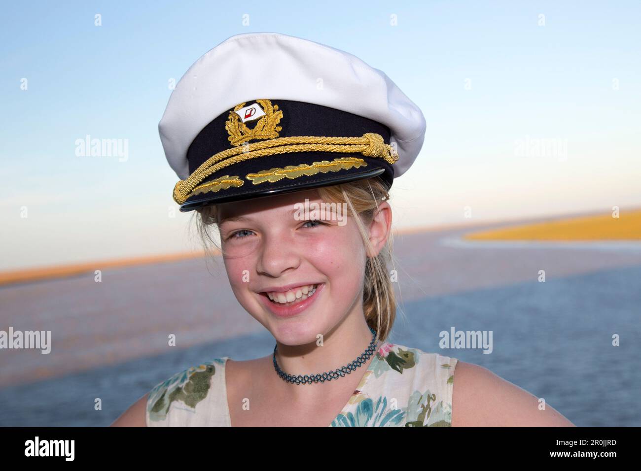Young girl with captain's hat aboard cruise ship MS Deutschland ...