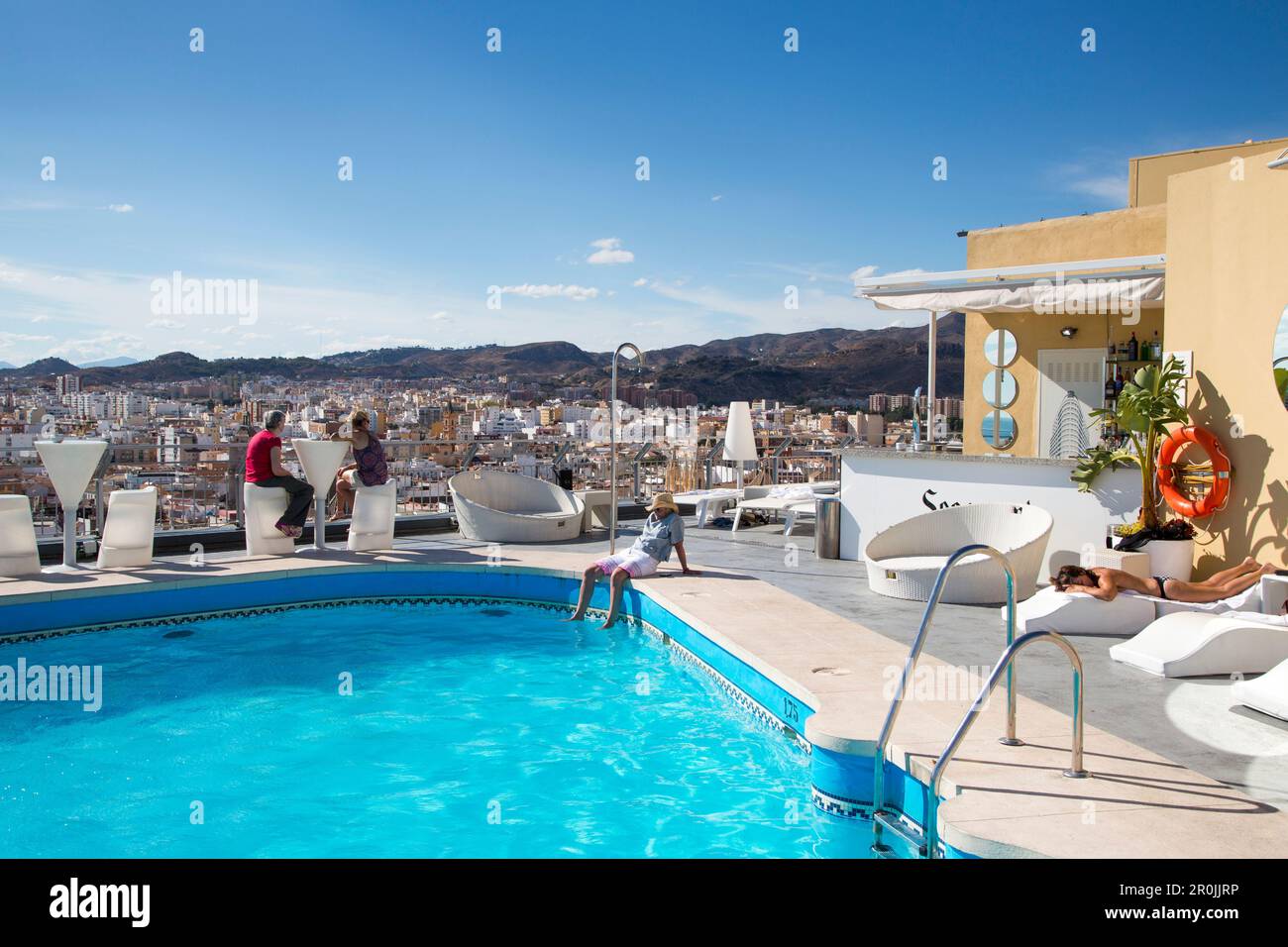 People relax at rooftop swimming pool of AC Hotel Malaga Palacio by ...