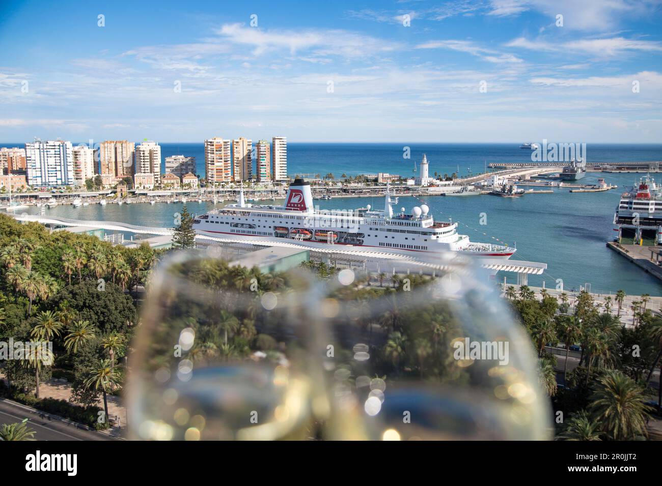 Wine glasses, palm trees and cruise ship MS Deutschland (Reederei Peter ...
