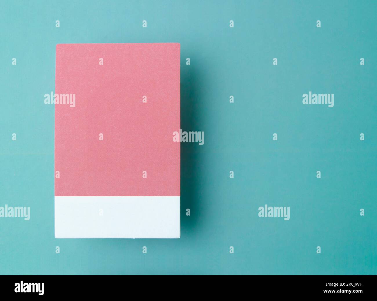 Blank adhesive sticky note on a green cardboard background with copy ...