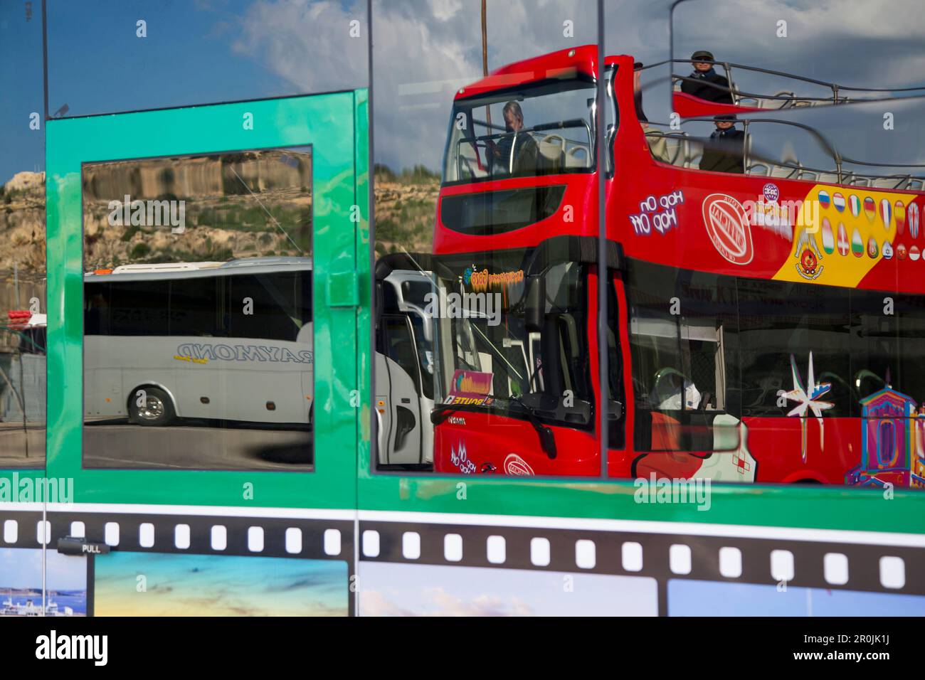 Reflection of Hop on Hop off City Sightseeing Gozo bus in tour bus ...