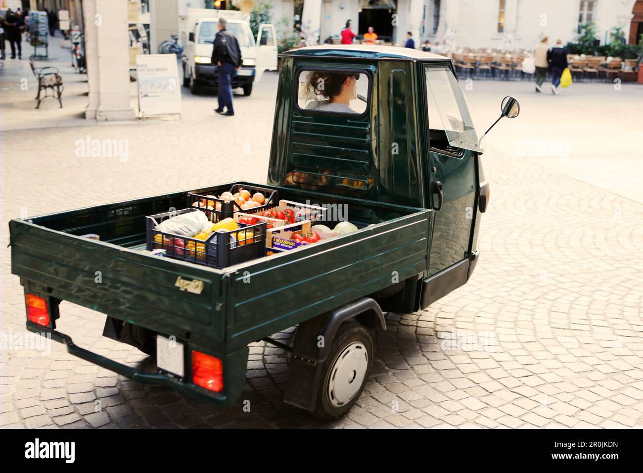 Pickup loaded with vegetables passing the old town, Arco, Trentino ...