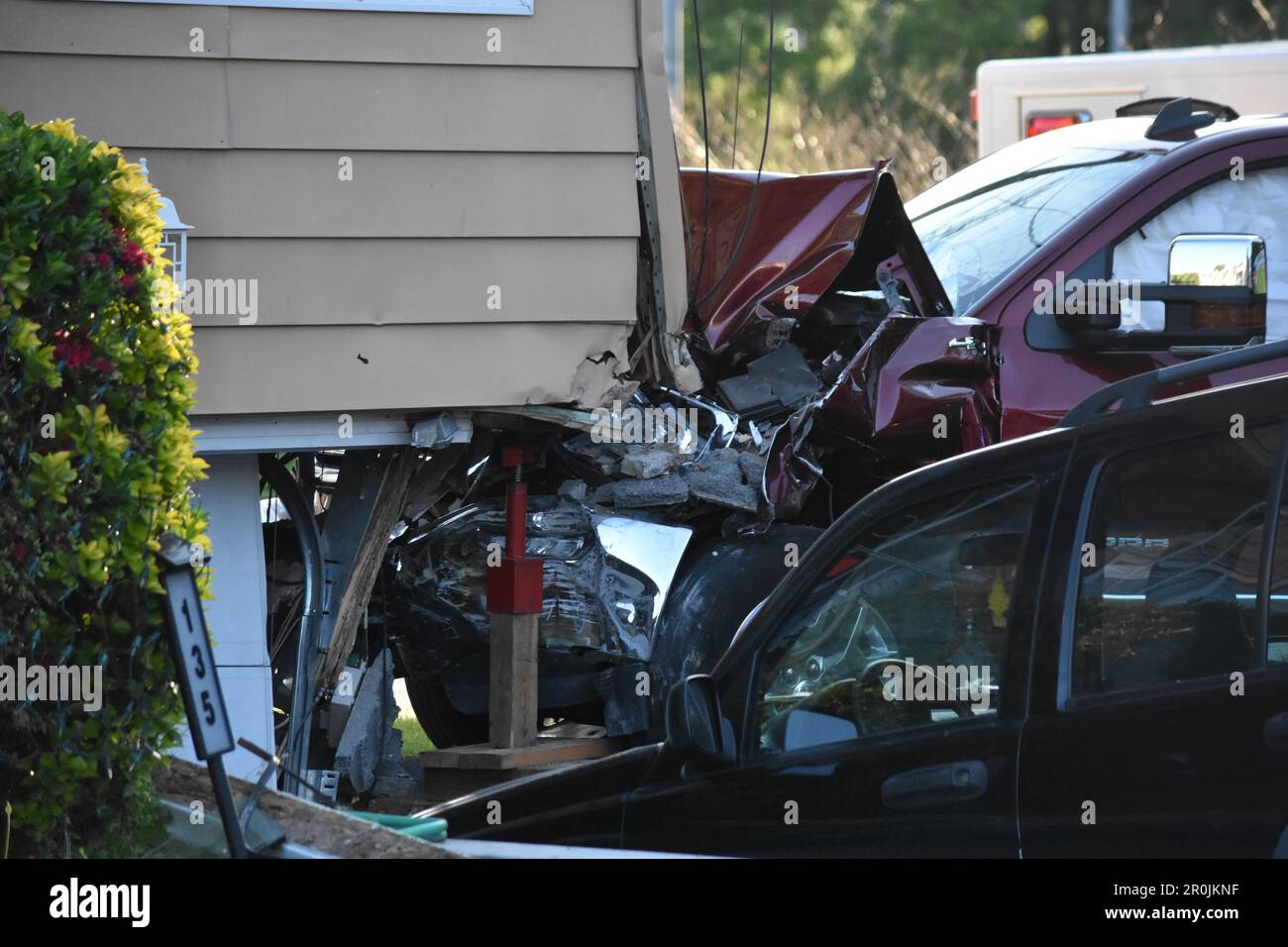 Truck seen crashed into the side of the house rendering the structure ...