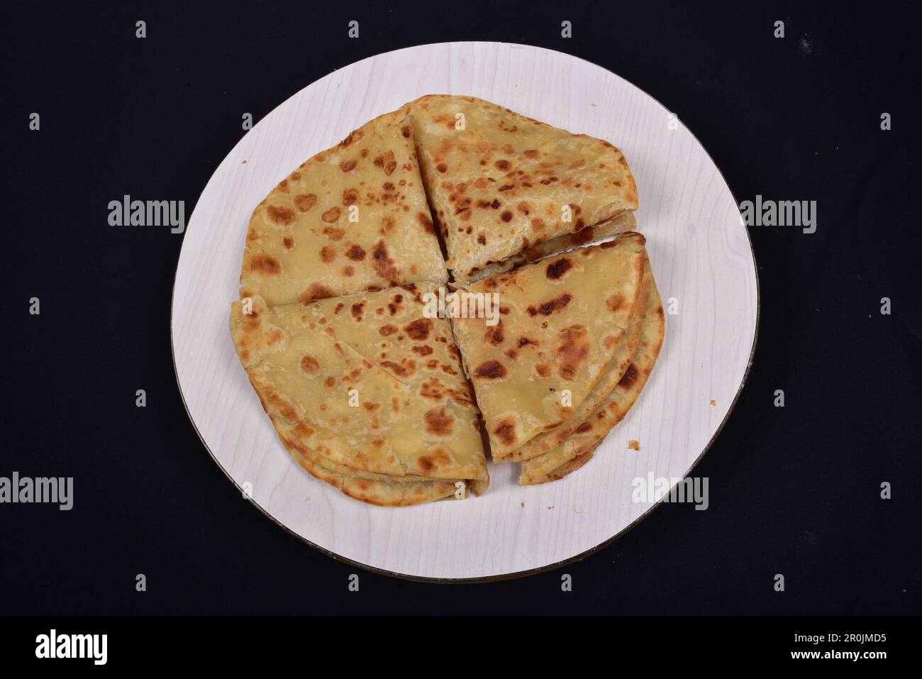 African Chapati folded into quarters on a black background Stock Photo ...