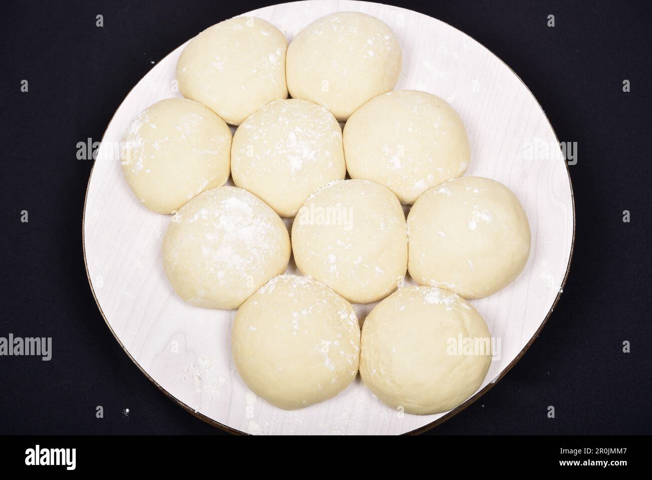 African Chapati dough divided into round balls on a rolling board Stock ...