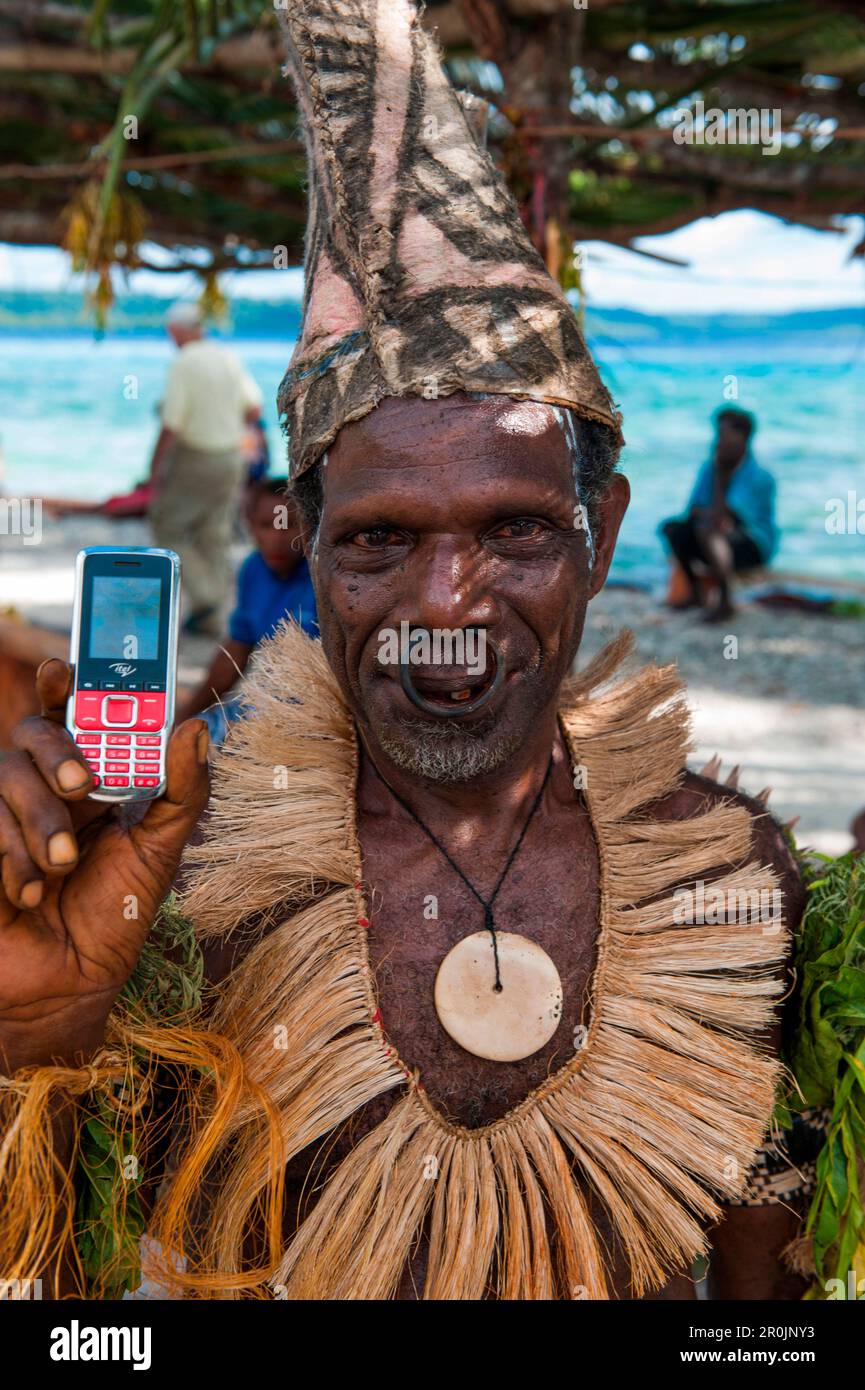 Tribesman holds mobile phone, Nendo Island, Santa Cruz Islands, Solomon ...