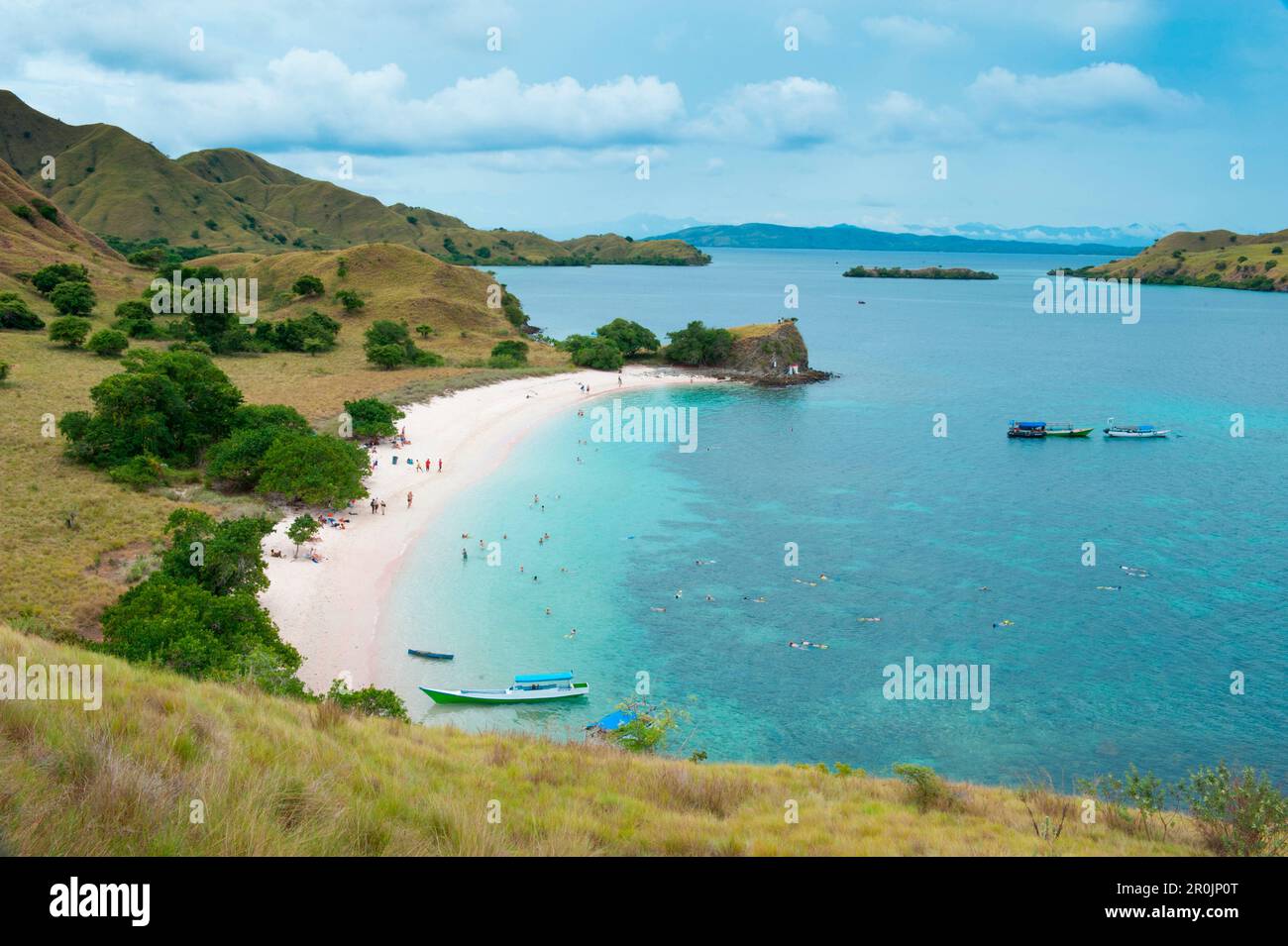 Overhead of Pink Beach with people swimming, Komodo, Indonesia, Asia ...