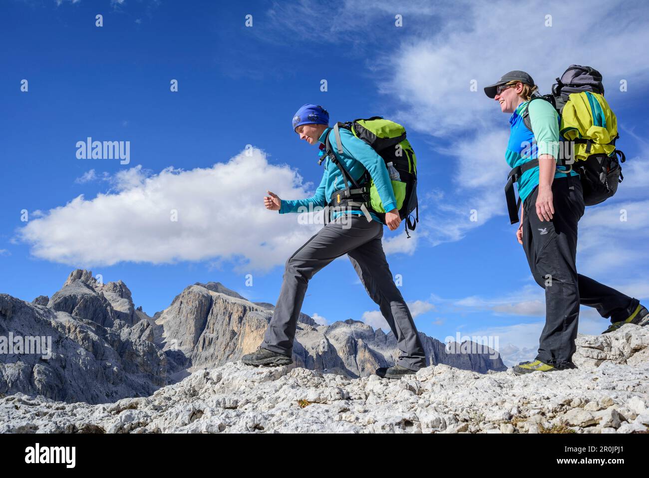 Two women hiking on rocky path, Cimon della Pala and Cima della Vezzana ...