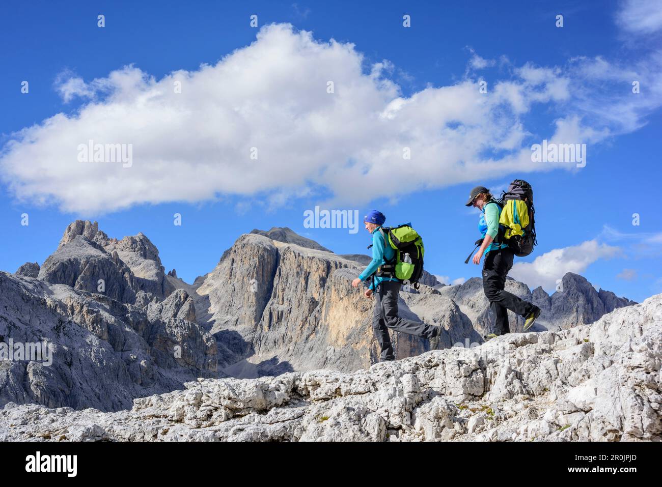 Two women hiking on rocky path, Cimon della Pala and Cima della Vezzana ...