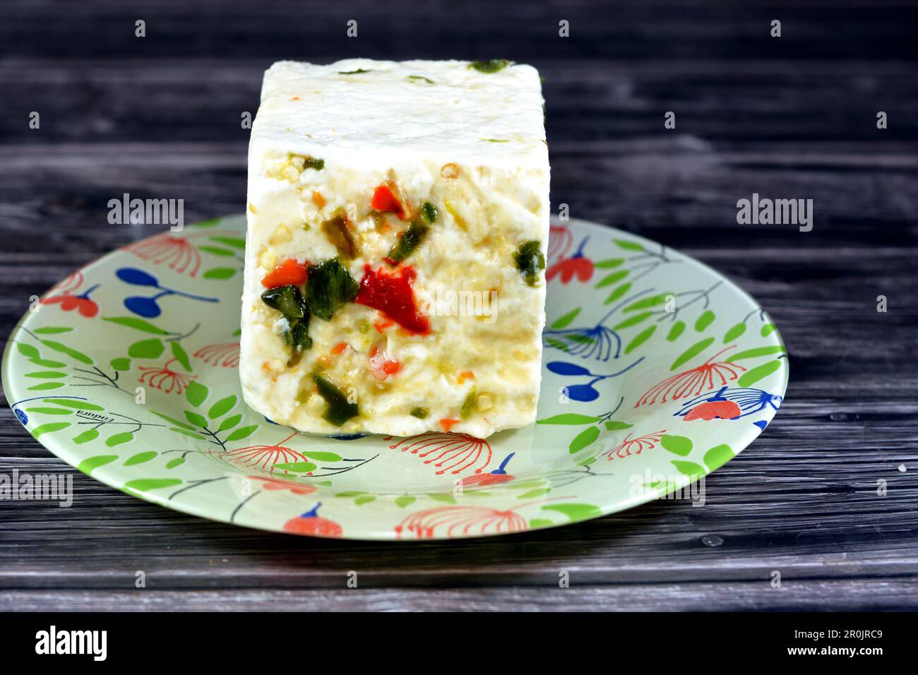 Aplate with a cube of Egyptian barrel Baramily white cheese with slices ...