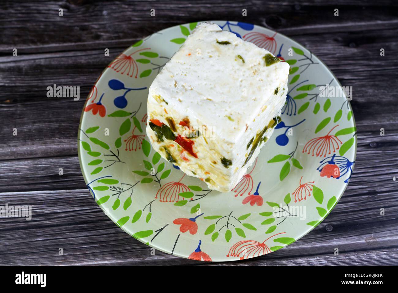 Aplate with a cube of Egyptian barrel Baramily white cheese with slices ...