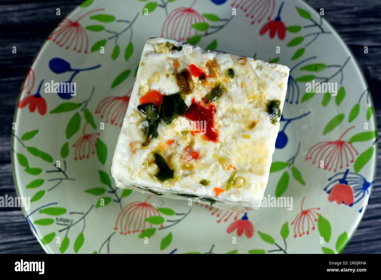 Aplate with a cube of Egyptian barrel Baramily white cheese with slices ...
