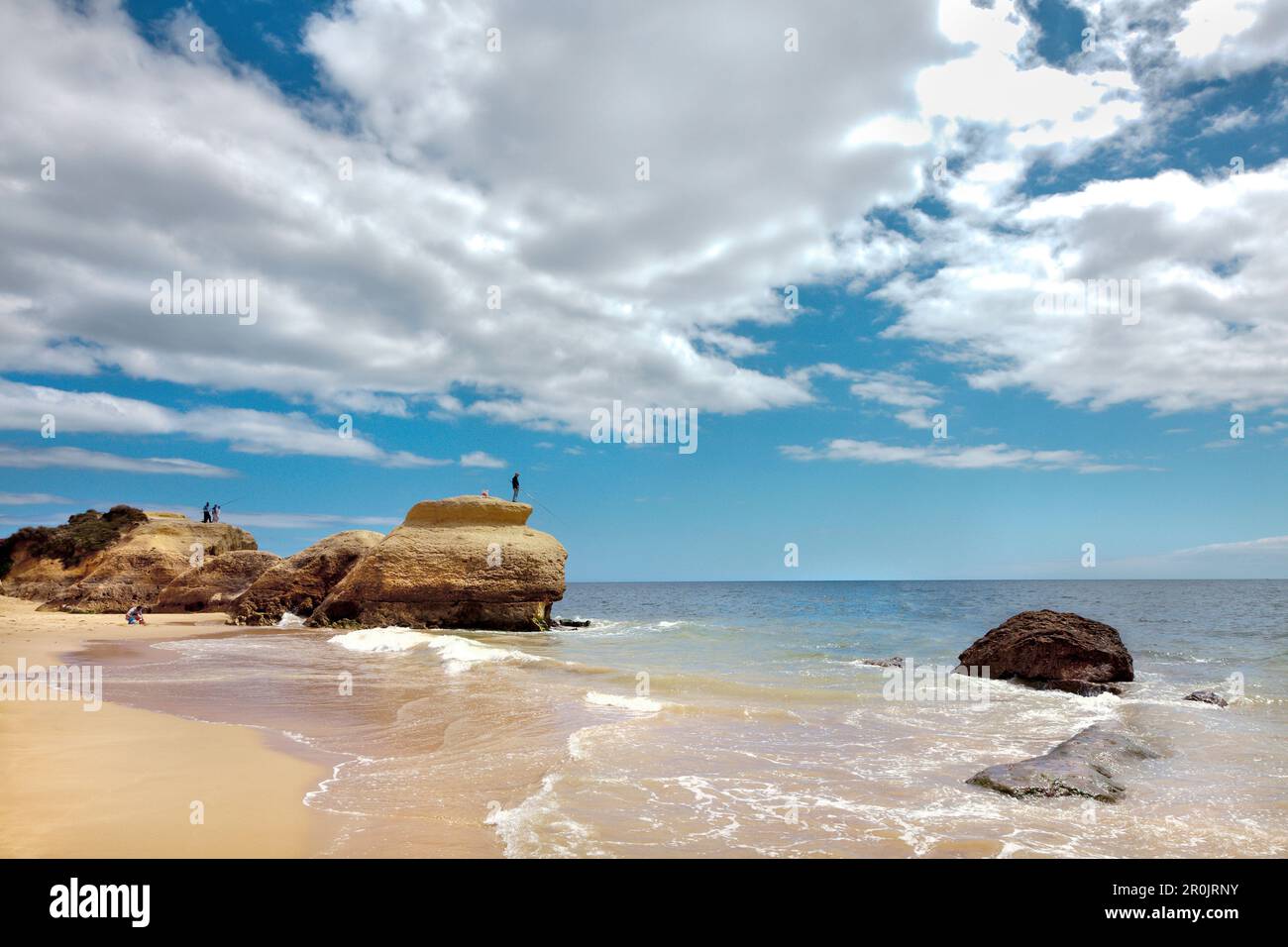 Fisher on a rock, Praia da Gale, Algarve, Portugal Stock Photo - Alamy
