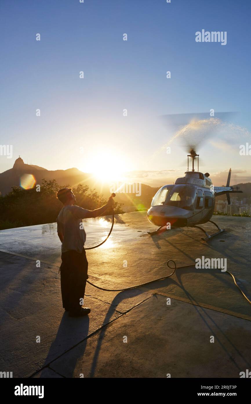 Helicopter rotors being cleaned with fresh water after helicopter ...