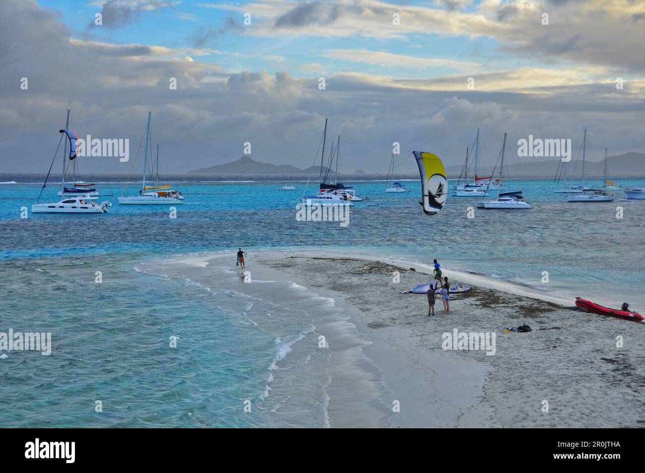 kite surfers on a beach at Baradel island, sailing ships and island of ...