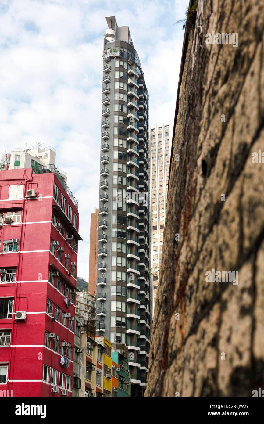 Tall and narrow skyscraper, red residential building, street scene ...