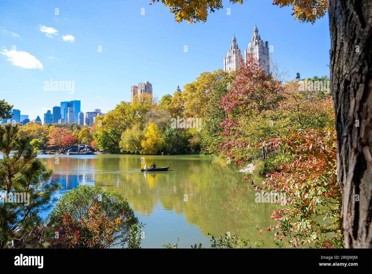 couple in a rowing boat on The Lake, Autumn with colourful trees ...