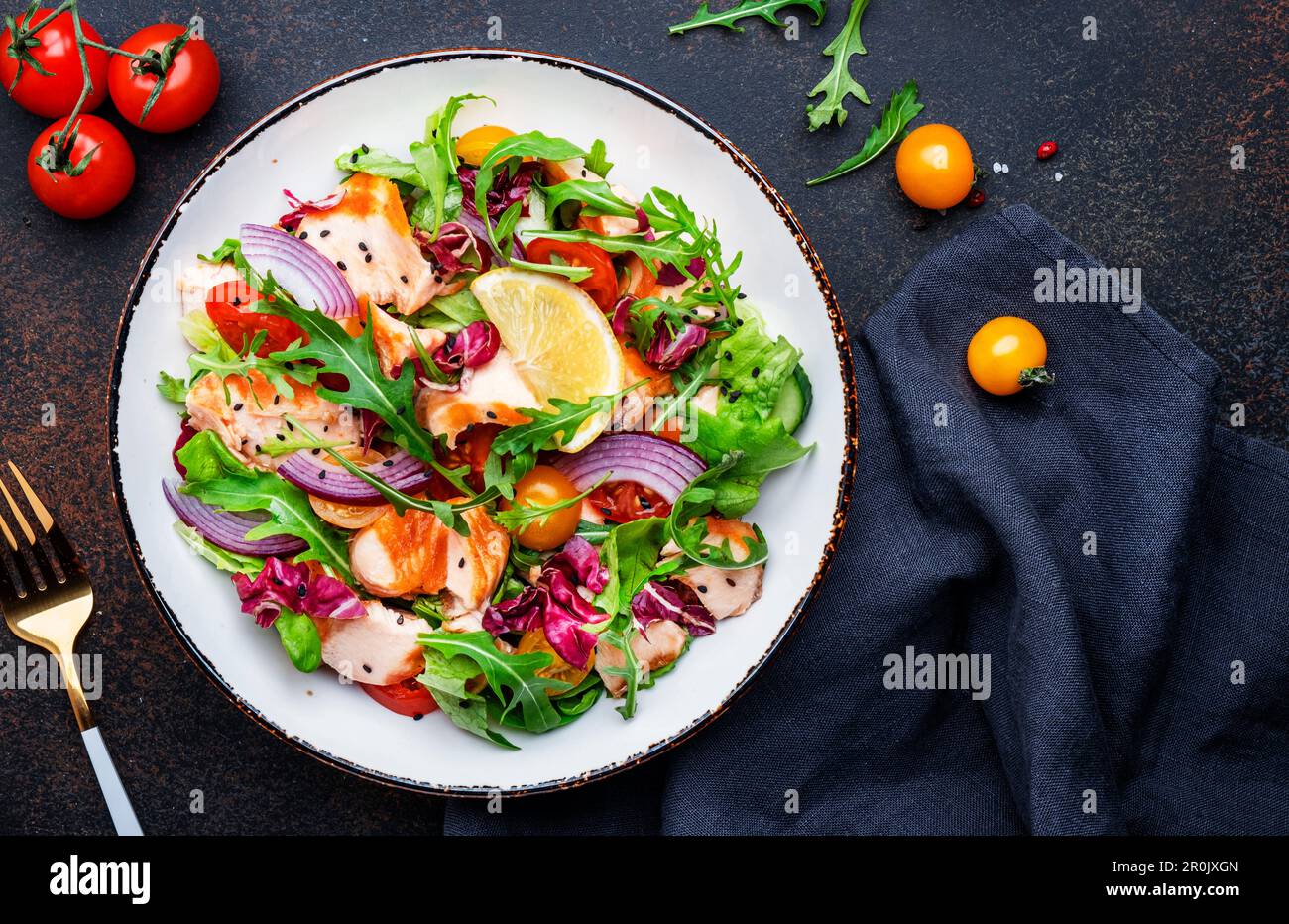 Gourmet salad with grilled salmon with tomatoes, cucumber, arugula ...