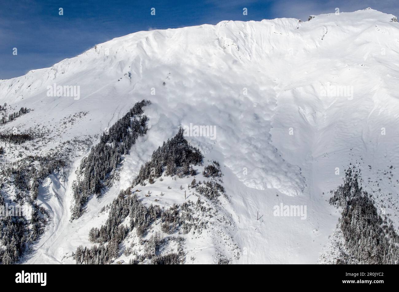 An artificially triggered massive avalanche is racing down the full ...