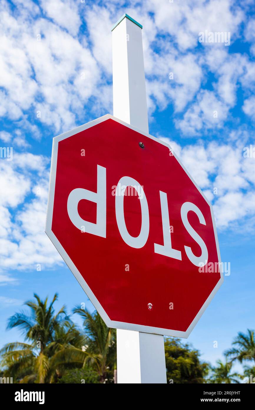 Stop sign which by defective connection hangs down head first, Ft ...