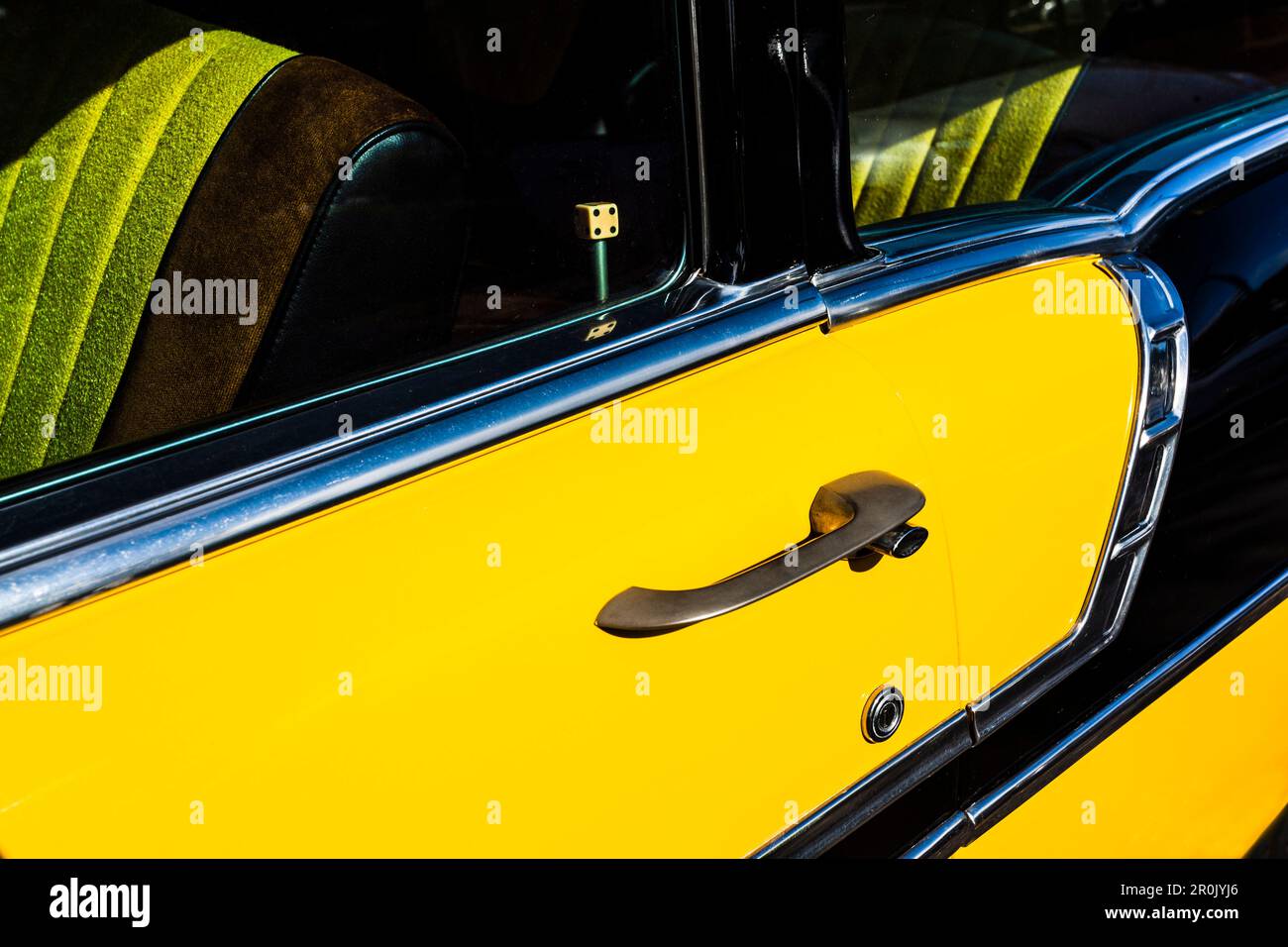 Vintage American car with flashy yellow painting and cube as doorbolt ...