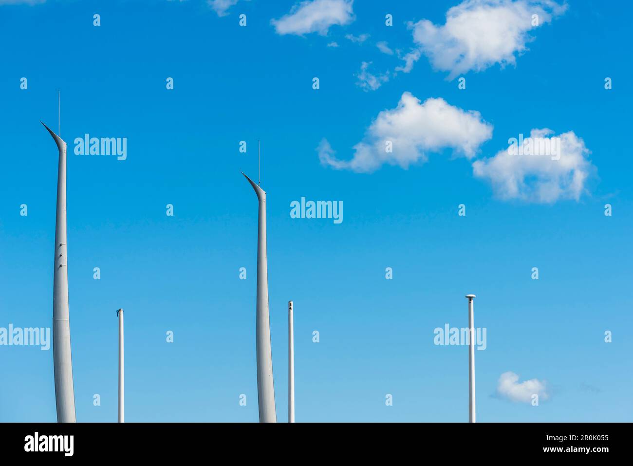 The masts of a modern sailing ship and flagpoles in the harbour, Kiel ...