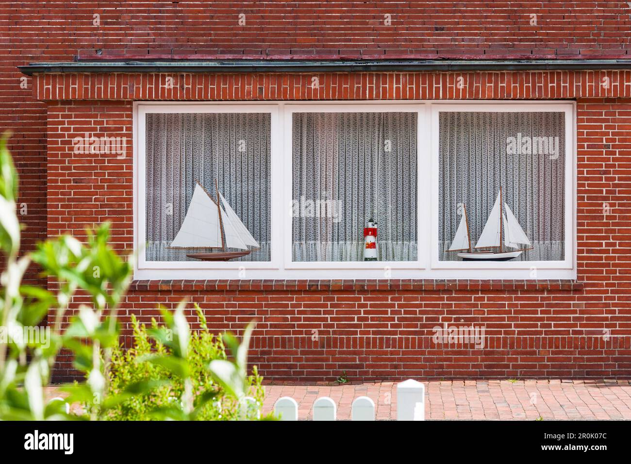 Two sailing ships and a lighthouse as models in the window of a typical ...