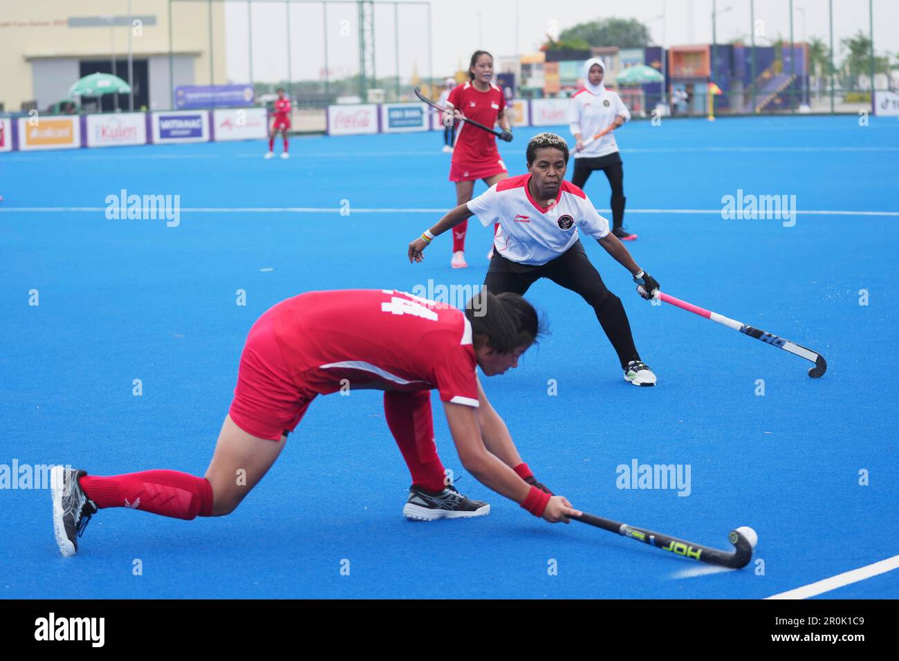 Singapore's Limin Toh, left, hits the ball against Indonesia's Novita ...