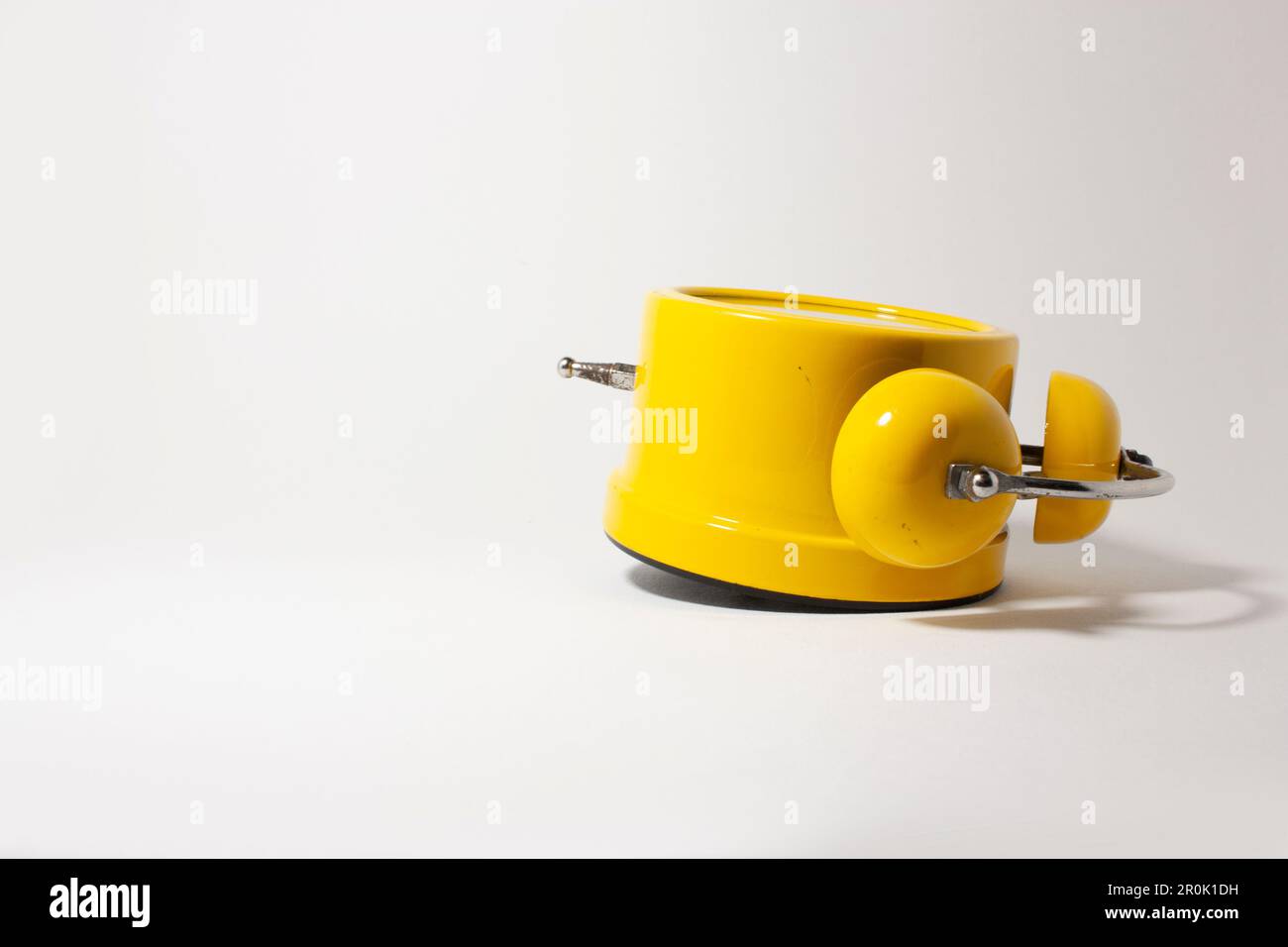 alarm clock yellow on white background Stock Photo - Alamy