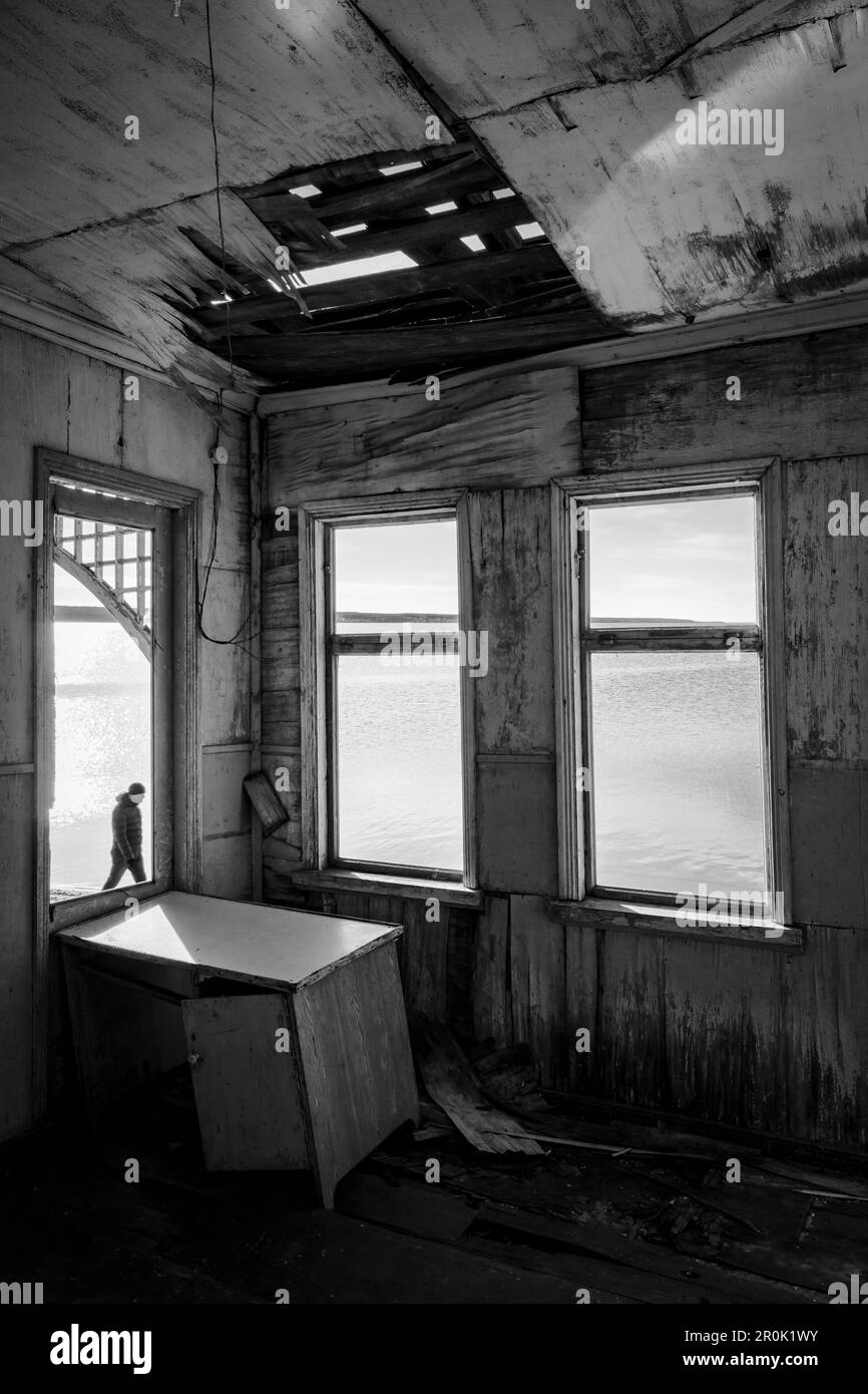 A room of an abandoned wooden house with empty windows without glass ...