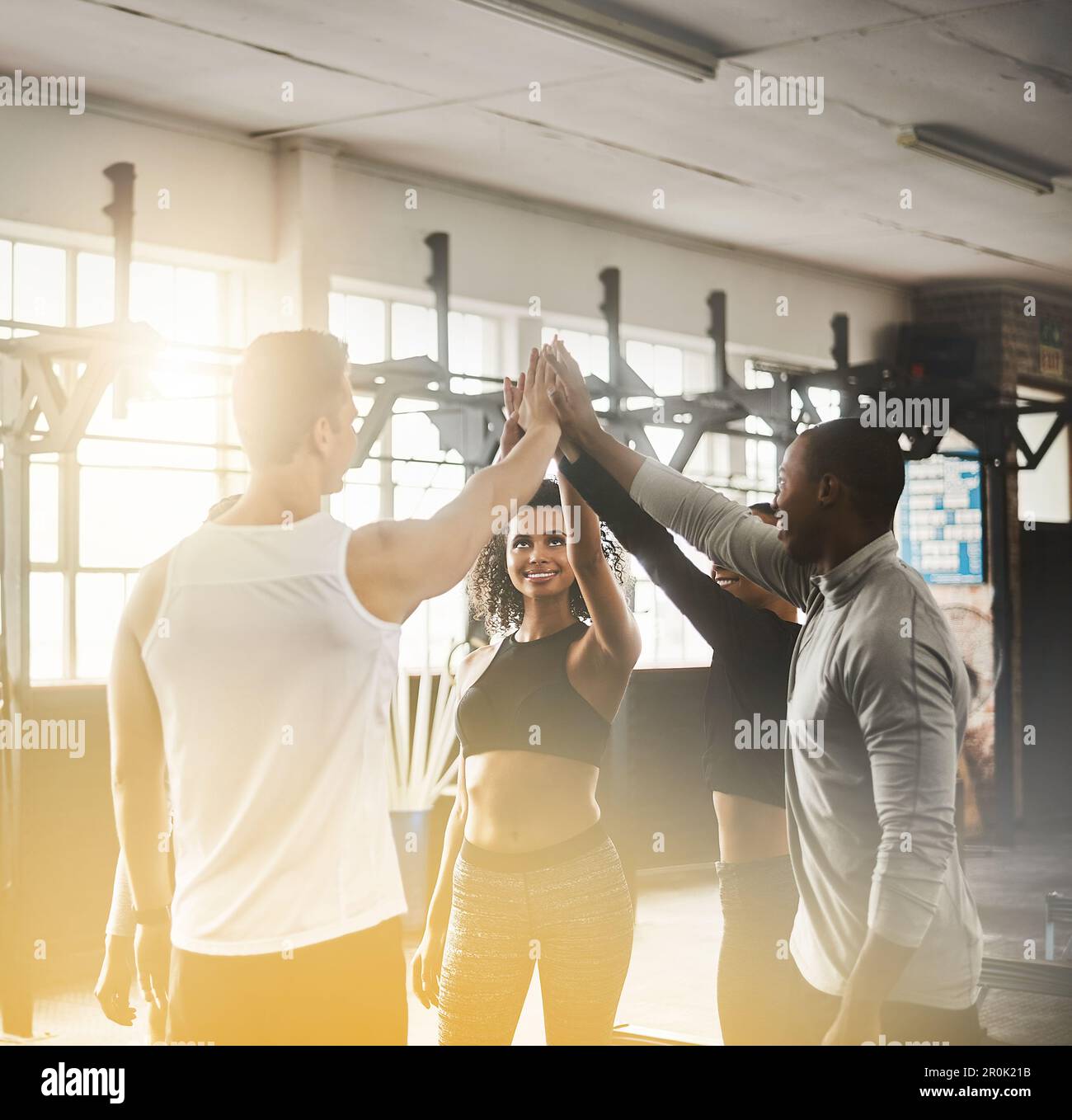 Celebration, high five and teamwork of people in gym for fitness, team building or solidarity ...
