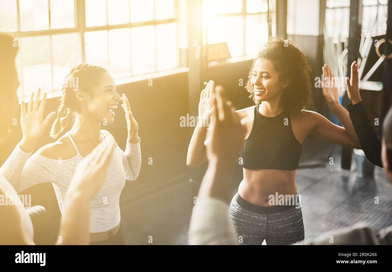 Funny, high five and teamwork of people in gym for fitness, team ...
