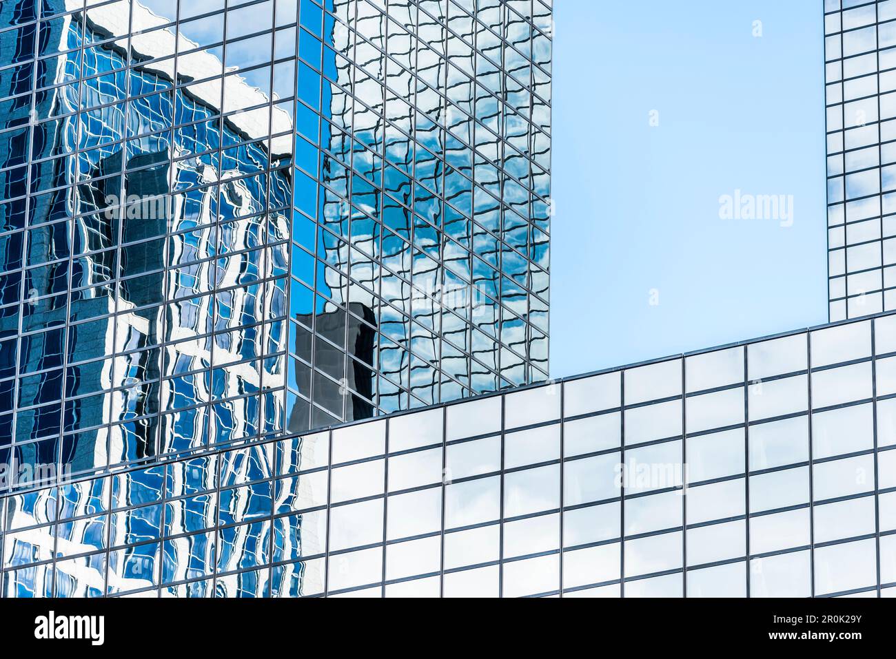 The glass facade one of many modern high-rise office blocks in the city ...