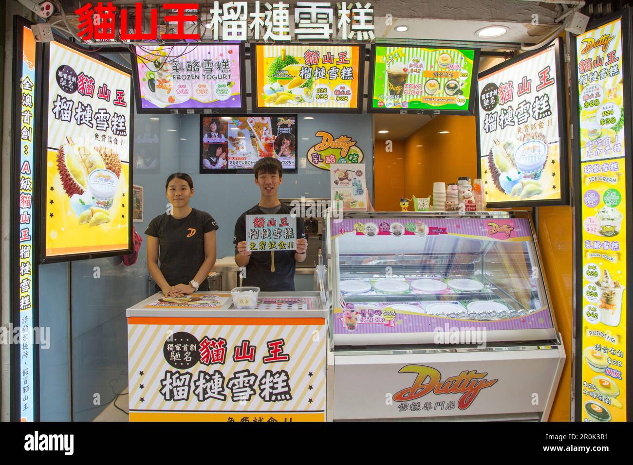 Two salesmen in colorful ice cream and snack shop, Taipa, Macau, China ...