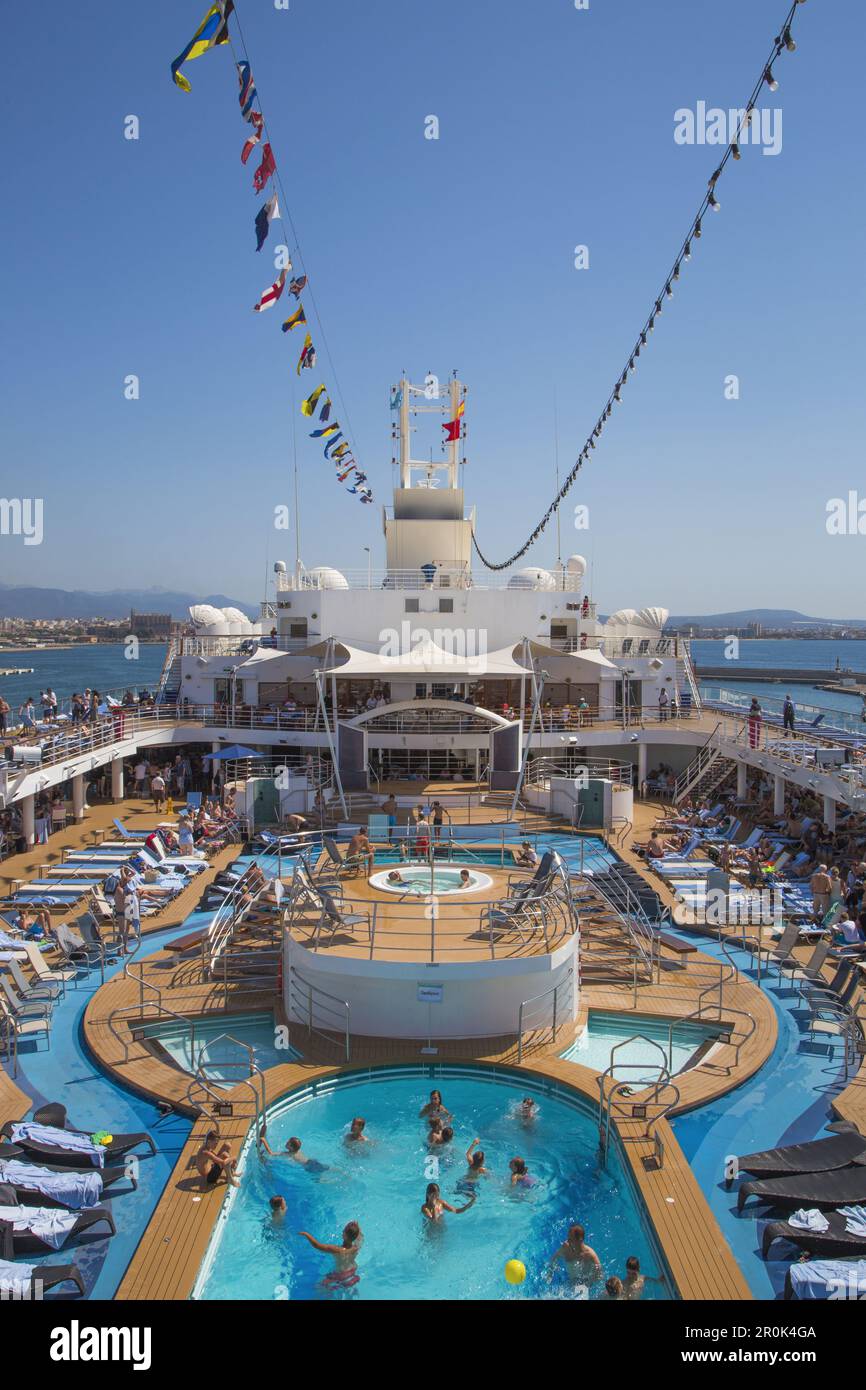 People in swimming pool and on deck aboard cruise ship Mein Schiff 2 ...