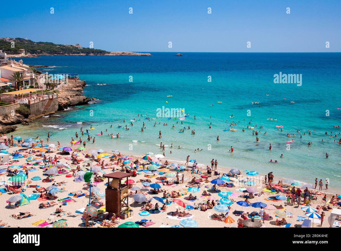 Crowds at Cala Ratjada beach during peak season, Cala Ratjada, Mallorca ...