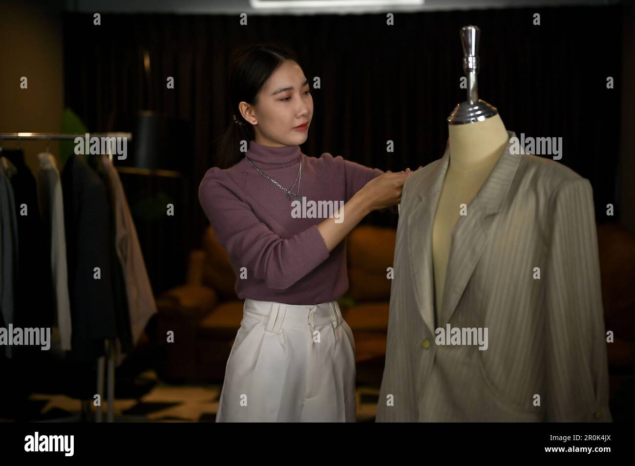 Beautiful and professional Asian female fashion designer or tailor ...