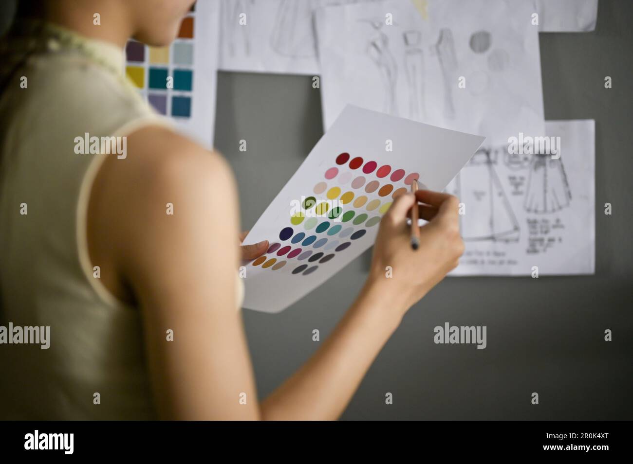 Close-up image of a professional Asian female fashion designer choosing ...
